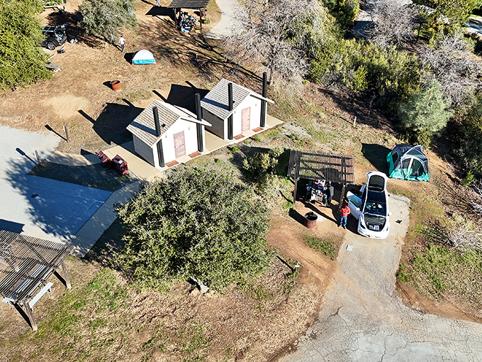 Campground comforts nestled among the oaks. These simple structures promise the luxury of waking up to birdsong instead of alarm clocks.