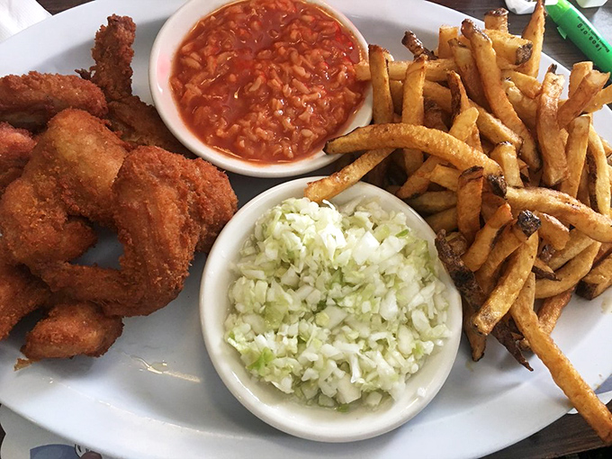 A plate that says "diet starts tomorrow" in the most delicious way possible&mdash;crispy wings, fresh-cut fries, and those essential sides.