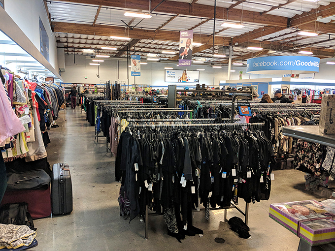 Organized chaos in the clothing section, where yesterday's fashion finds new admirers. Black garments hang like a uniform for the fashion-forward treasure hunter.