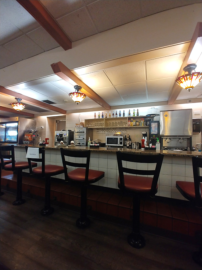 Counter seating offers front-row tickets to the breakfast theater where Belgian waffle magic happens daily.