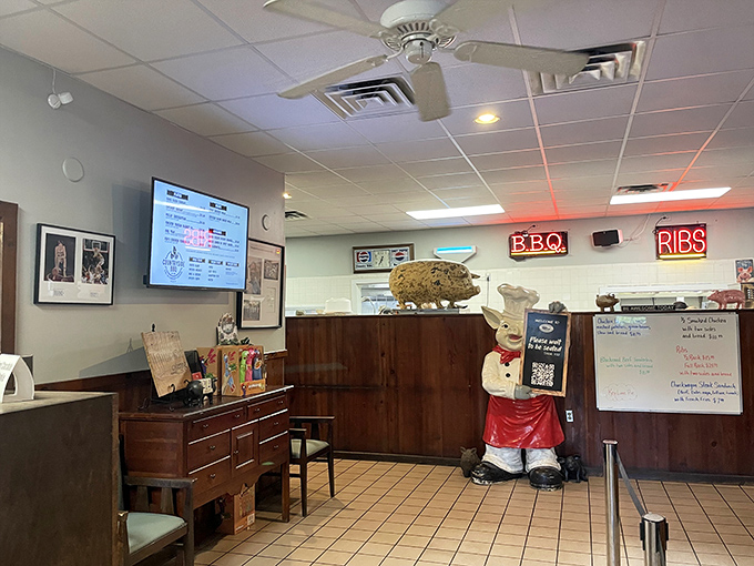 The chef's statue stands guard by the counter, a whimsical reminder that barbecue is serious business with room for joy.