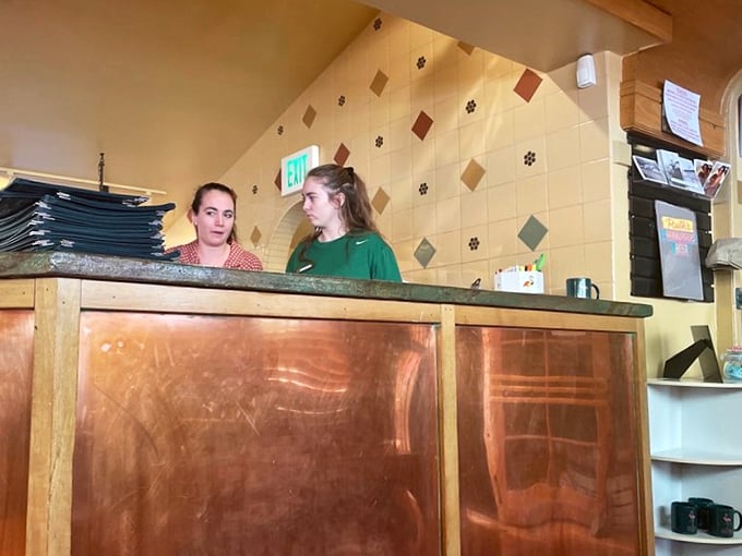 Behind this copper-fronted counter, culinary dreams become reality while staff orchestrate the delicious chaos with practiced precision.