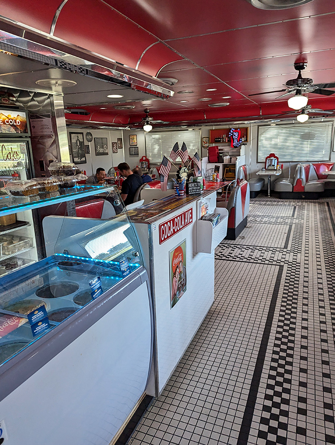 Where diner magic happens: gleaming display cases, patriotic touches, and the promise of dessert all within eyeshot of your table.