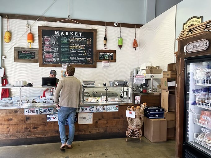 The market counter&mdash;where seafood dreams begin. Those license plates aren't just decoration; they're a nod to the East Coast roots of this California gem.