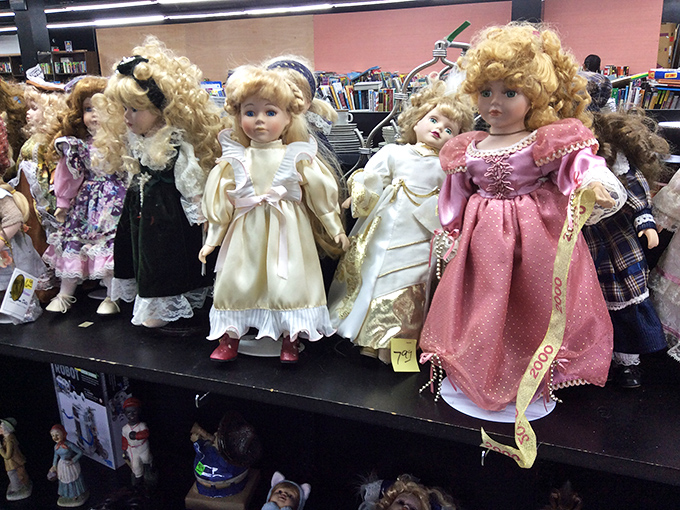 The doll collection stares back with the collective wisdom of childhood companions who've seen it all.