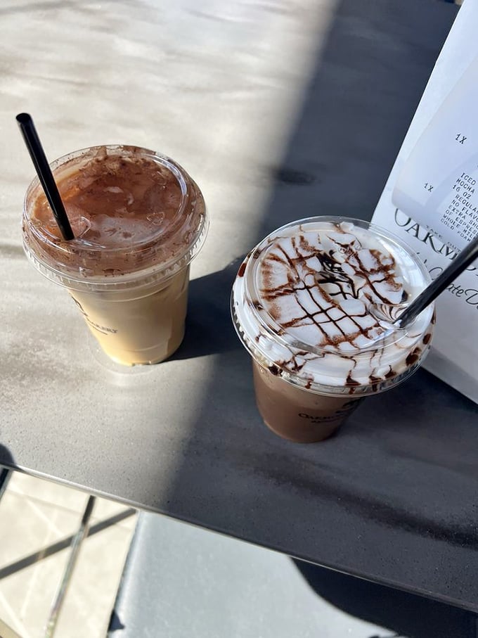 Coffee drinks lounging in the sunlight, their chocolate drizzles like contemporary art, waiting to fuel conversations and sugar rushes alike.