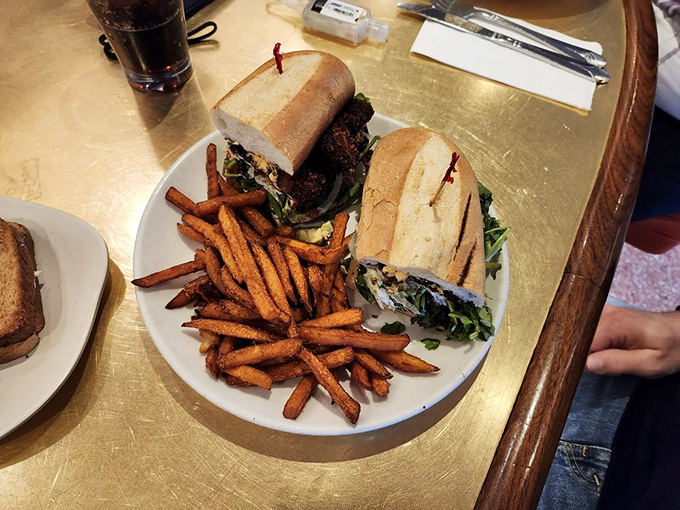 A sandwich that demands two hands and several napkins, paired with fries that could make a Frenchman renounce citizenship.