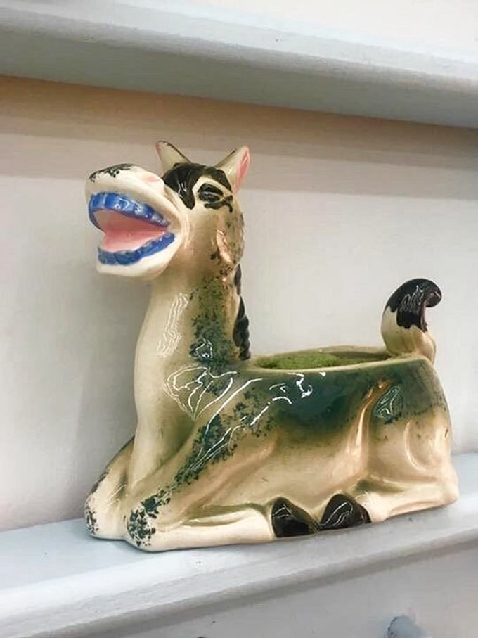 That ceramic donkey planter has seen things. With its mischievous grin and glazed finish, it's begging for a second life on someone's shelf.
