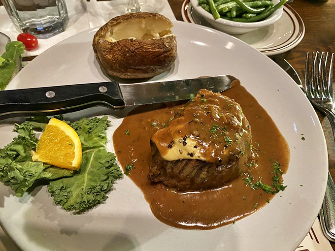 This filet mignon, bathed in rich sauce and paired with a perfect baked potato, makes a compelling case for ordering beef at a seafood joint.