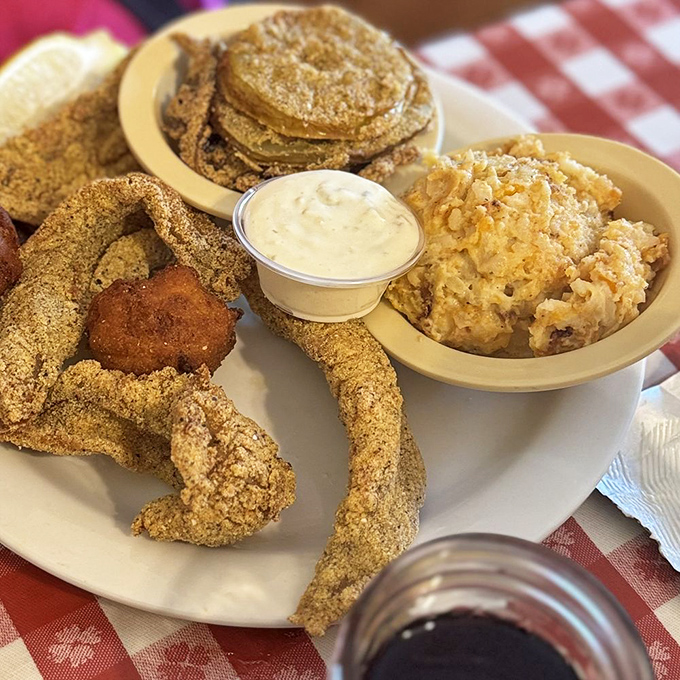 Cornmeal-crusted catfish, fried to golden perfection alongside hash browns and hush puppies. This plate has more Southern credentials than a Tennessee Williams play.