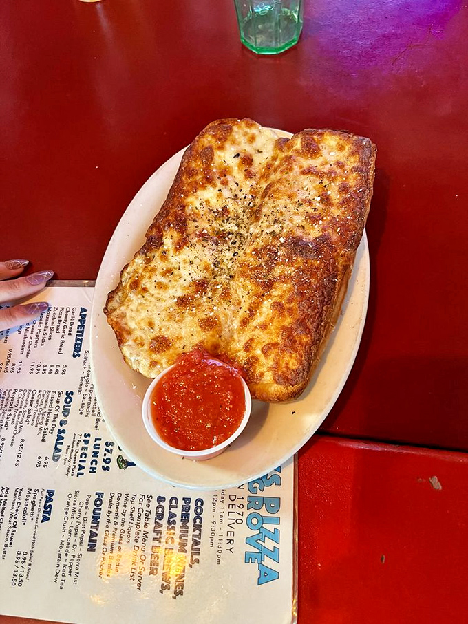 Garlic bread that's achieved the perfect golden ratio of crisp exterior to pillowy interior. The side of marinara isn't optional&mdash;it's essential.