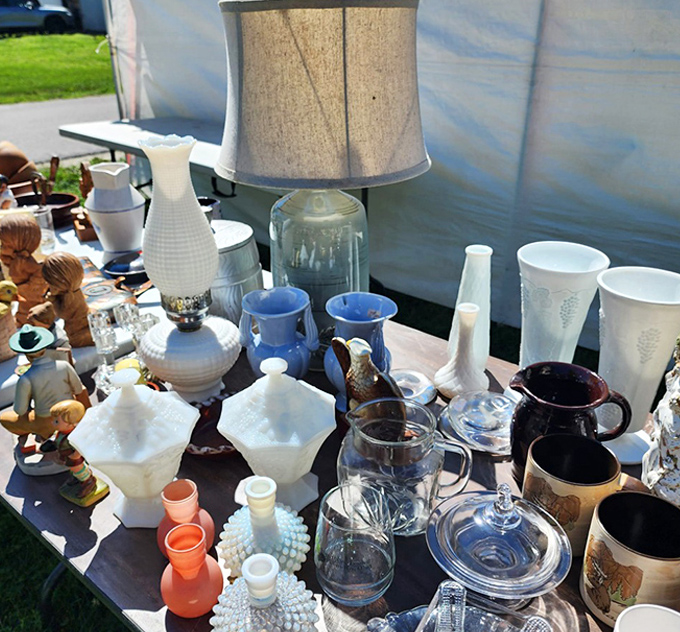 Milk glass, vintage pitchers, and delicate glassware catching the sunlight. Grandma's china cabinet could use that perfect missing piece found here.
