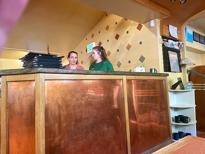 The host stand welcomes you like an old friend, promising that beyond this wooden gateway lies a world of culinary comfort.