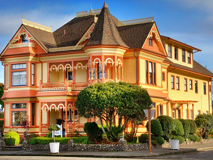 The Gingerbread Mansion lives up to its fairytale name with its vibrant yellow exterior, ornate trim, and the promise of Victorian luxury within its storied walls.