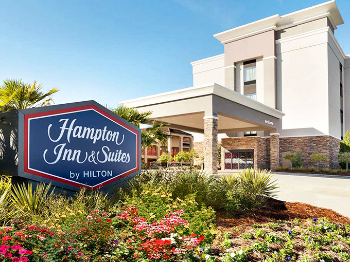 The Hampton Inn's landscaped entrance offers weary travelers a comfortable respite without Manhattan prices &ndash; proving affordable comfort isn't an oxymoron.