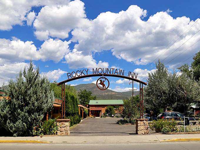 The Rocky Mountain Inn's entrance promises Western hospitality without the kitschy cowboy overkill. Just genuine mountain charm waiting beyond that arch.