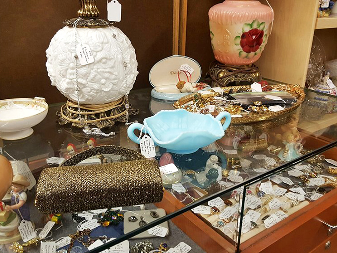 Delicate treasures under glass&mdash;from milk glass to costume jewelry&mdash;each piece once made someone feel special. That blue sugar bowl probably served Sunday best company.