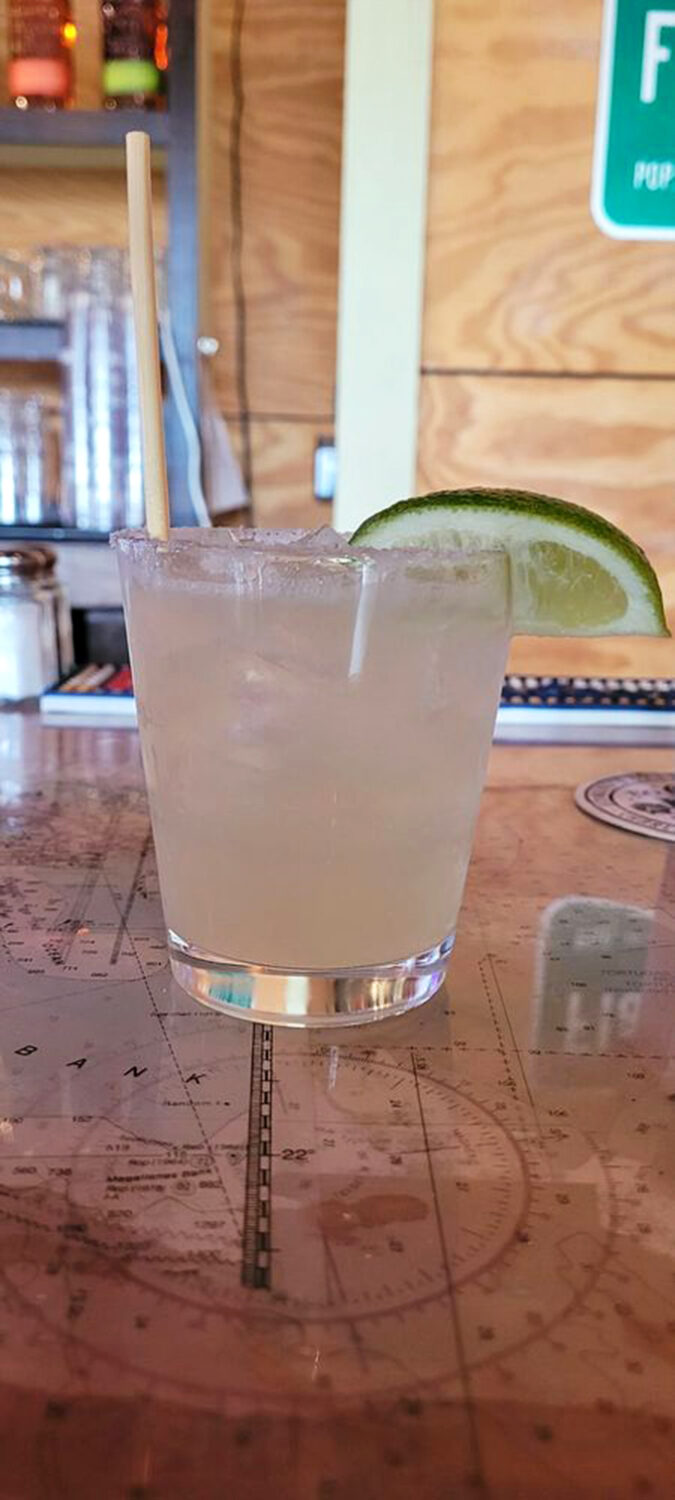 Clear liquid, lime wedge, salt rim&mdash;this margarita isn't complicated, just completely perfect. Served atop what appears to be a nautical map, no less.