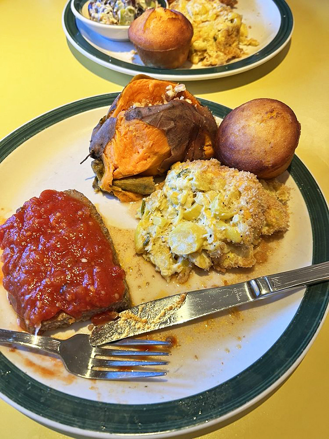 Meatloaf wearing a sassy tomato sauce hat, accompanied by mac and cheese that's having its own identity crisis as a vegetable.