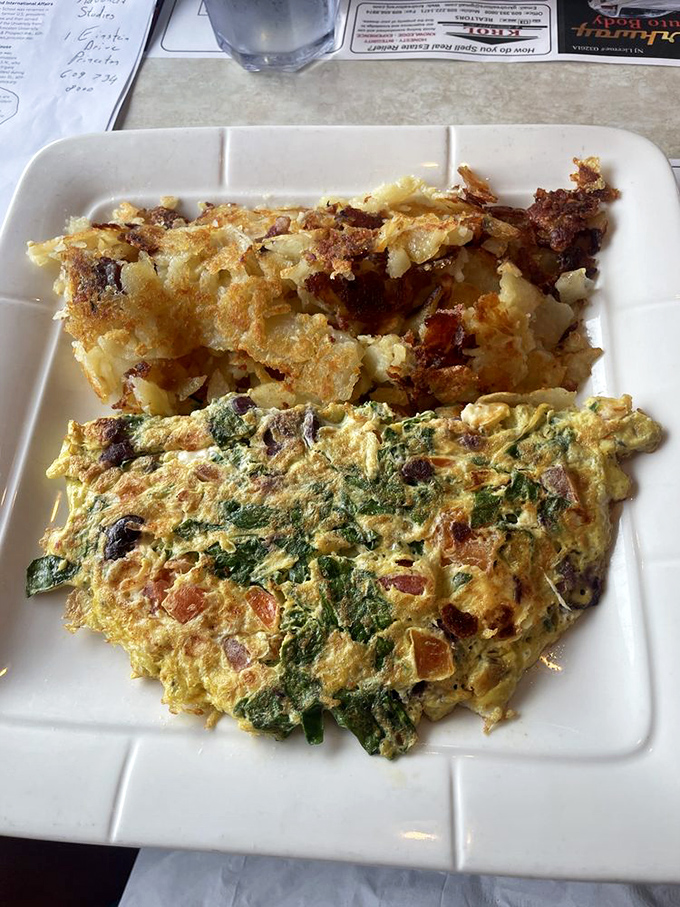 Whoever said "you can't have it all" never met this plate. A garden-fresh omelet meets crispy home fries in a breakfast romance for the ages.