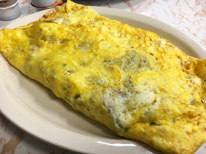 An omelet so perfectly executed it deserves its own winner's circle. Golden exterior, tender interior—this is breakfast engineering at its finest.