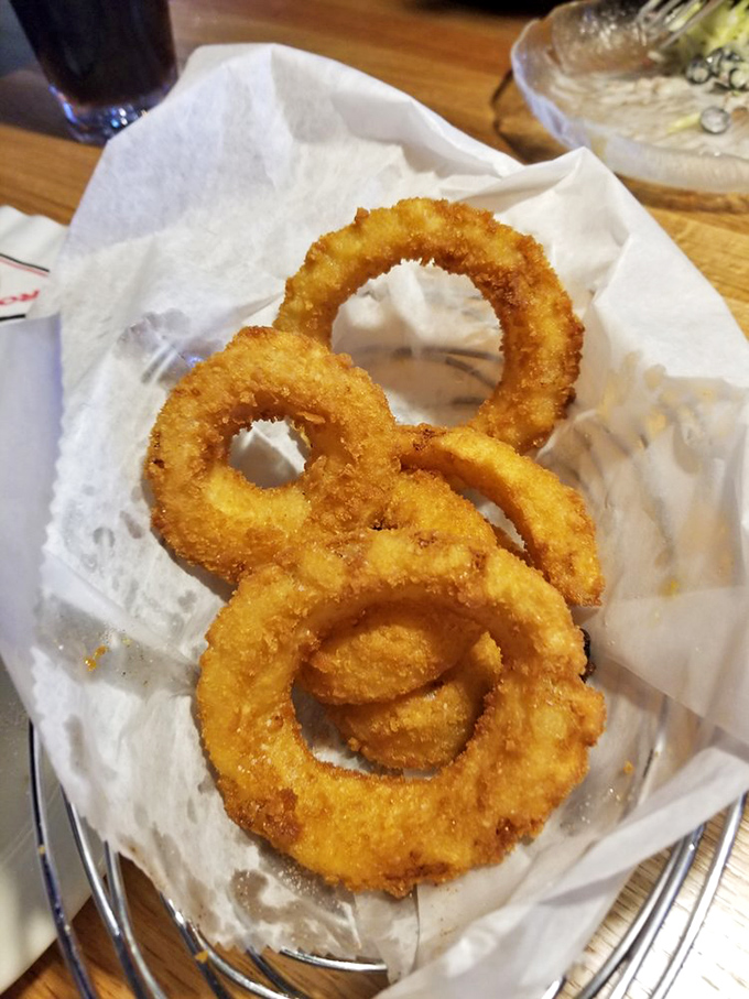 Golden onion rings stacked like delicious halos&mdash;crispy on the outside, tender within, and altogether worthy of your undivided attention.