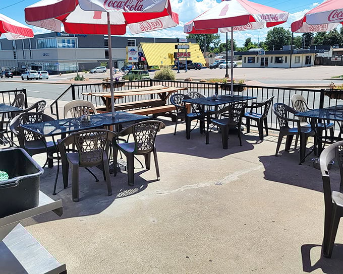 Outdoor seating under classic Coca-Cola umbrellas&mdash;because sometimes you need fresh air with your comfort food and a view of everyday America.