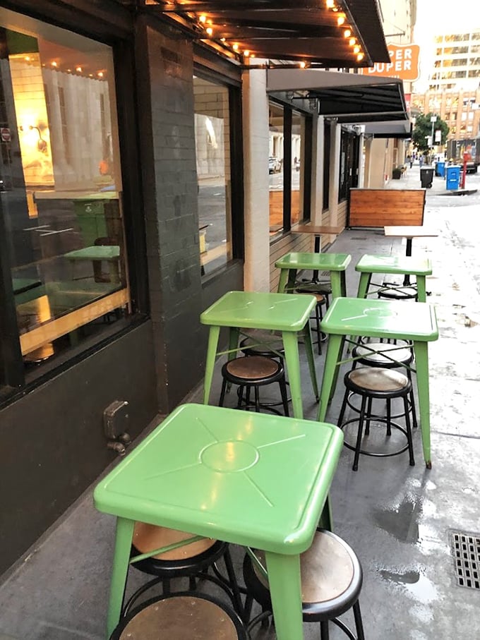 Those bright green tables outside aren't just furniture - they're front-row seats to the "I Just Had The Best Sandwich" facial expressions show.