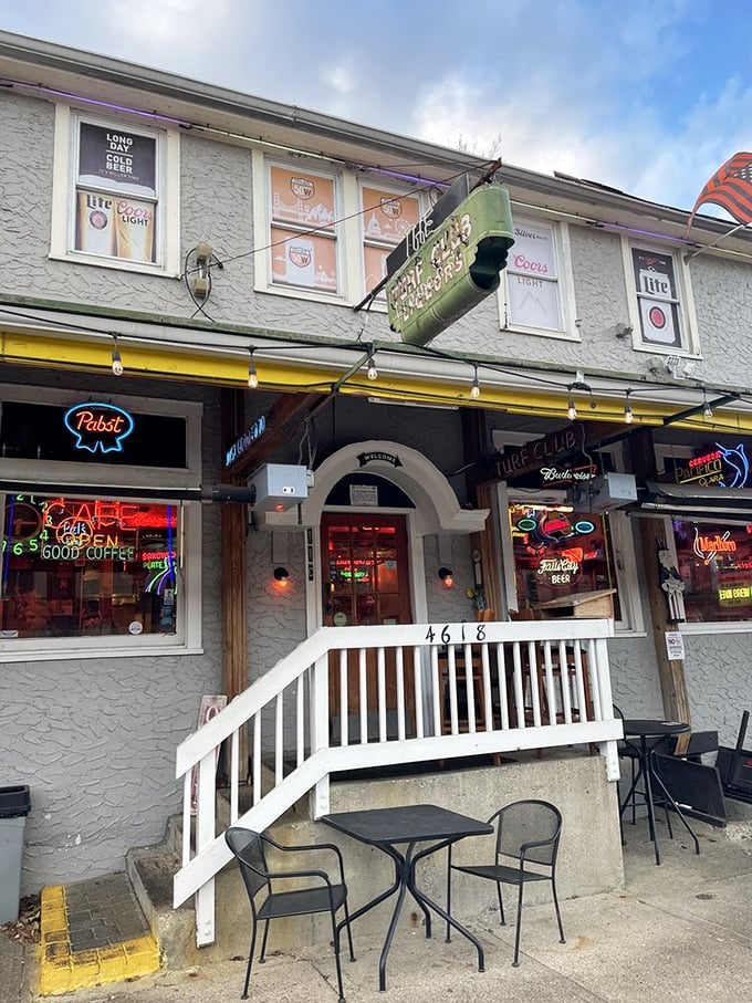 The entrance says "neighborhood joint," but the neon signs whisper "institution." That white railing has supported generations of satisfied customers.