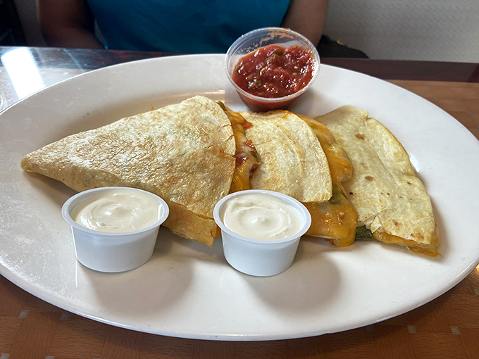 Quesadillas that understand the importance of proper cheese-to-tortilla ratio, with sour cream and salsa ready for dipping duty.