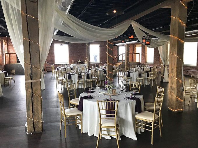 Industrial chic meets wedding elegance in this event space where exposed beams and flowing fabrics create matrimonial magic.