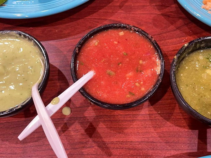 The holy trinity of salsas—each little bowl promising its own adventure from mild journey to five-alarm flavor explosion.