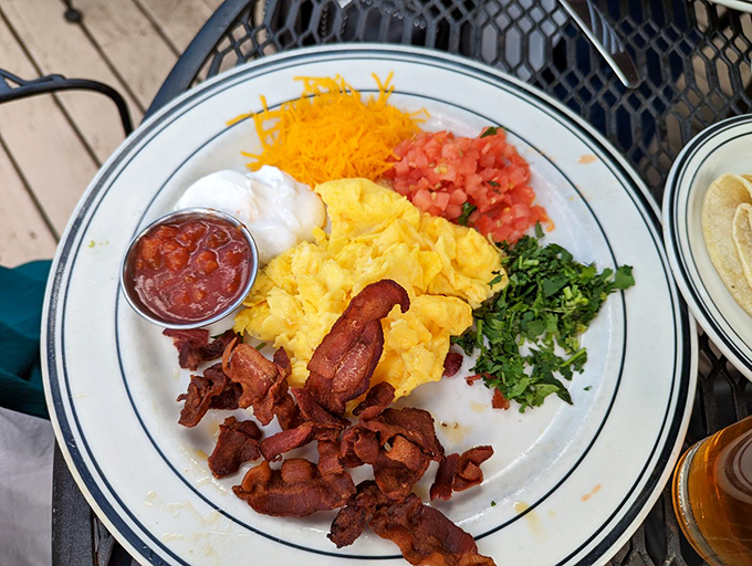 A breakfast fiesta on a plate &ndash; scrambled eggs surrounded by colorful toppings that make every bite a different adventure.