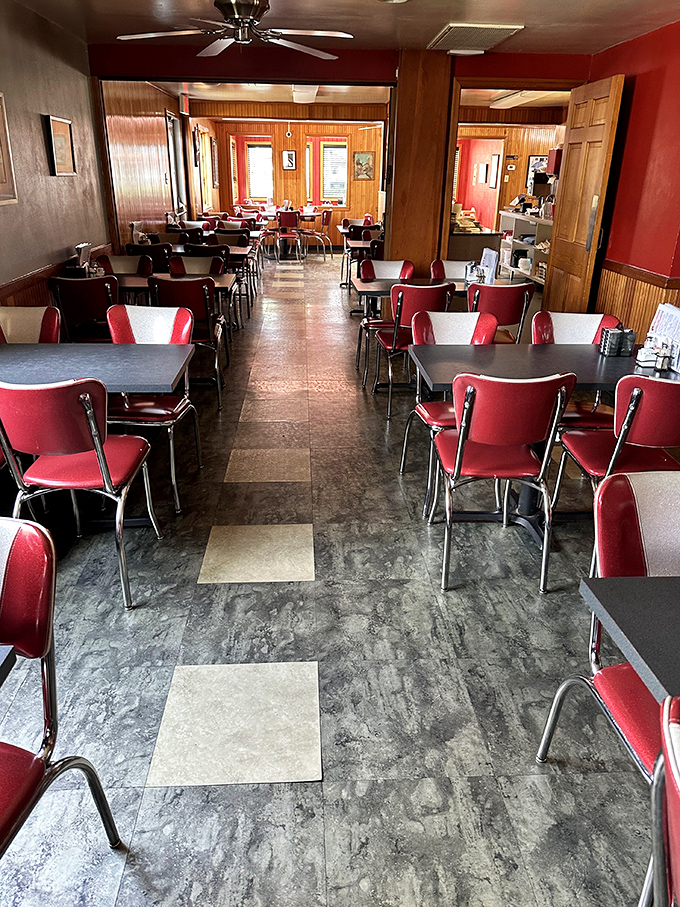 The dining room waits patiently for its next round of pie enthusiasts. Those red chairs have heard decades of "mmms" and "wows."