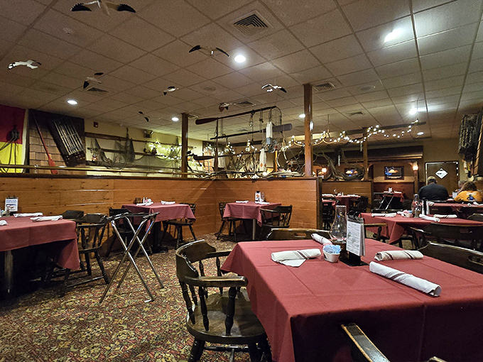 Red tablecloths and wooden chairs create that classic seafood house ambiance where memorable meals and conversations unfold.