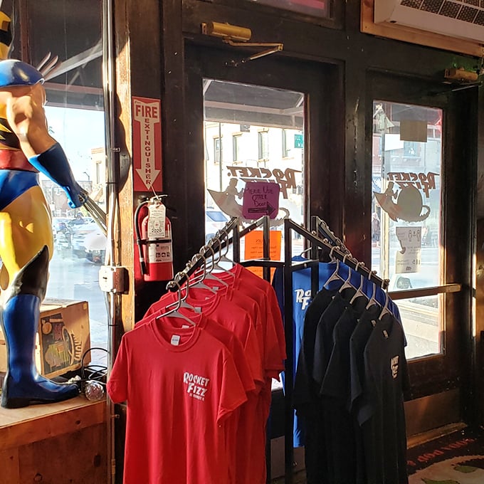 Rocket Fizz T-shirts hang by the entrance, perfect for those who want their wardrobe to announce "I make questionable but delicious dietary choices" to the world.