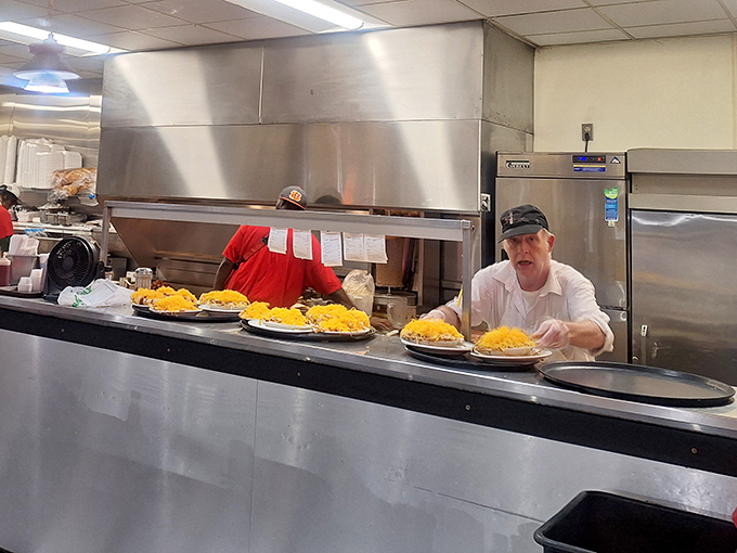 Behind the counter, the kitchen crew works their magic, sending out plates crowned with those signature mountains of finely shredded cheddar.