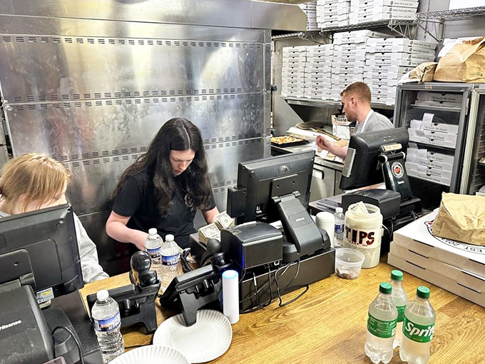 The engine room of flavor. Staff working with practiced precision, turning out masterpieces with the focus of artists and the efficiency of seasoned professionals.