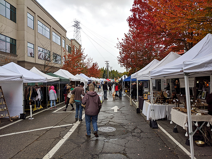 Autumn transforms the market into a canvas of crimson and gold, while shoppers hunt for treasures beneath white canopy villages.