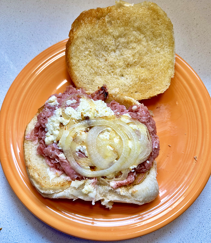 The chipped ham sandwich in its natural habitat &ndash; thinly shaved pink perfection topped with melted cheese and sweet onions on a toasted bun.