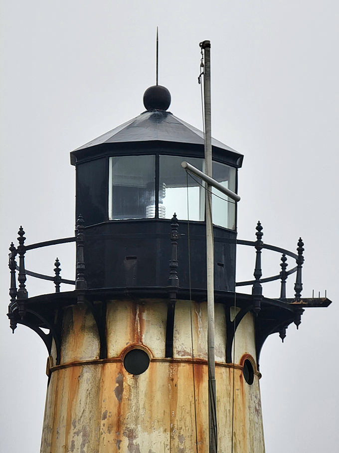The lantern room that's guided countless sailors safely home. Its elegant black crown against weathered white creates a timeless silhouette against the moody California sky.