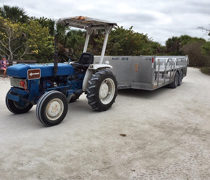 Island mass transit: a blue tractor pulling what might be the world's most rustic limousine service to nine miles of untouched beach.