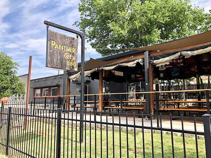 Panther City's rustic outdoor setup with wooden sign &ndash; where Fort Worth's barbecue renaissance found its beating heart.