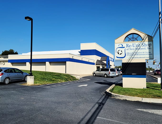 Re-Uzit Shop's charming sign announces its mission with a clever name that would make any dad joke enthusiast give a respectful nod. 