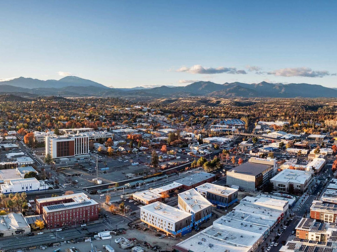Redding's downtown aerial view reveals a city embraced by mountains, where urban conveniences meet affordable living.