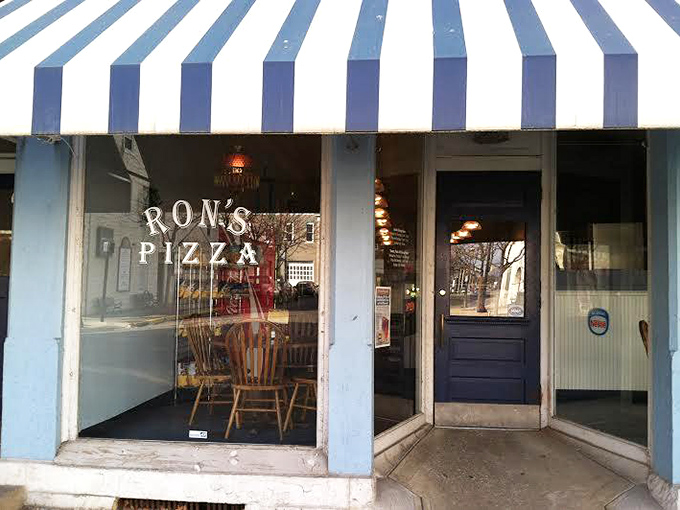 Ron's blue and white awning stands guard over pizza traditions that have outlasted eight presidents and countless food trends.