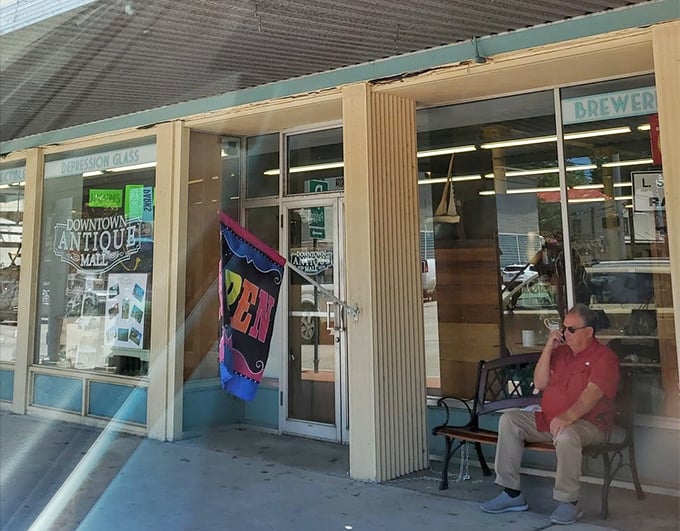 The weathered wooden doors and brick exterior hint at the authentic vintage experience waiting inside this New Braunfels gem
