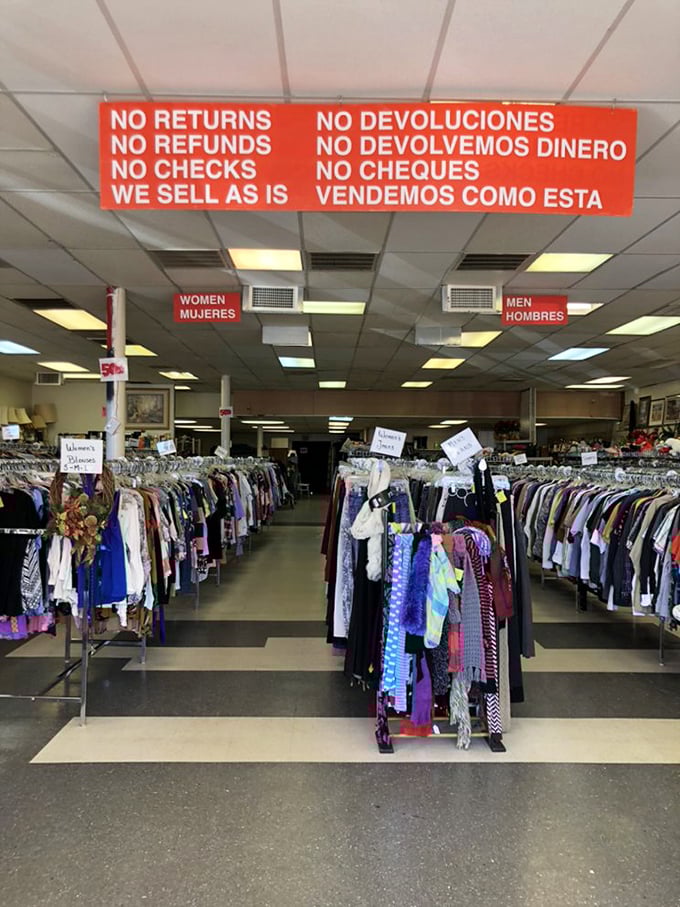 Inside Friendly Thrift Store, racks of clothing await new homes. The "No Returns" sign is thrift store code for "Choose Wisely!"
