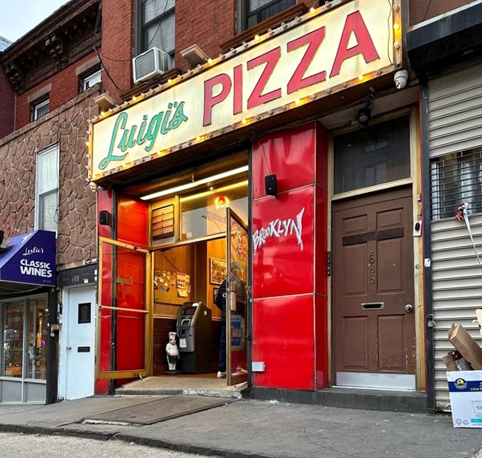 The worn edges of Luigi's facade tell stories of decades serving pizza perfection to grateful Brooklynites.