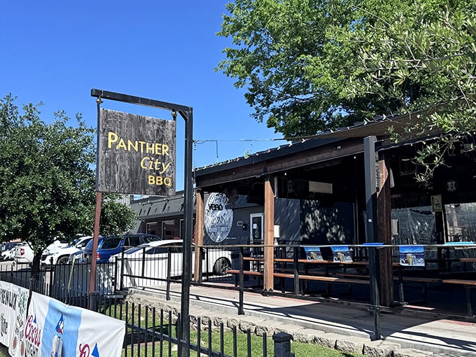 The wooden fence and simple sign hide Fort Worth's smoky treasure &ndash; where Texas tradition meets backyard party vibes.